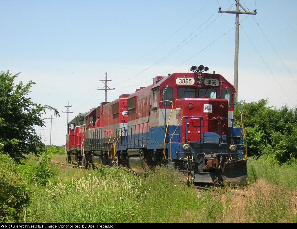 HESR 3865 and 3 other GP-38-2's wait by an old junk yard outside of Saginaw Michigan
